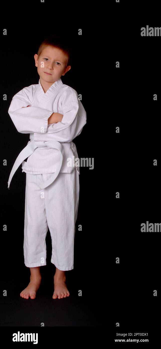 Young boy in karate outfit making fighting movement Stock Photo - Alamy