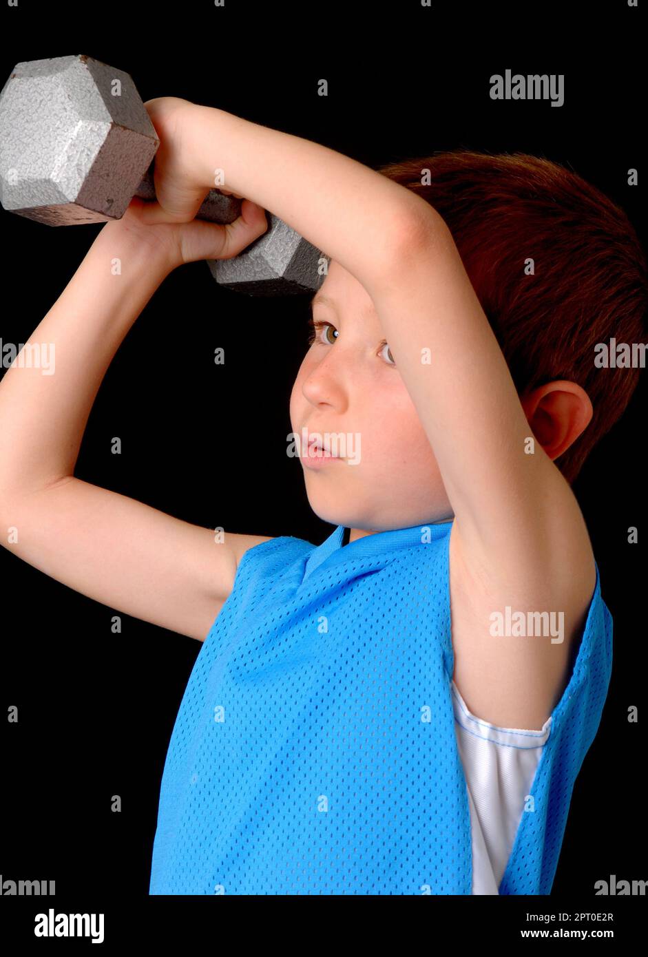Young boy lifting weight that is too heavy Stock Photo - Alamy