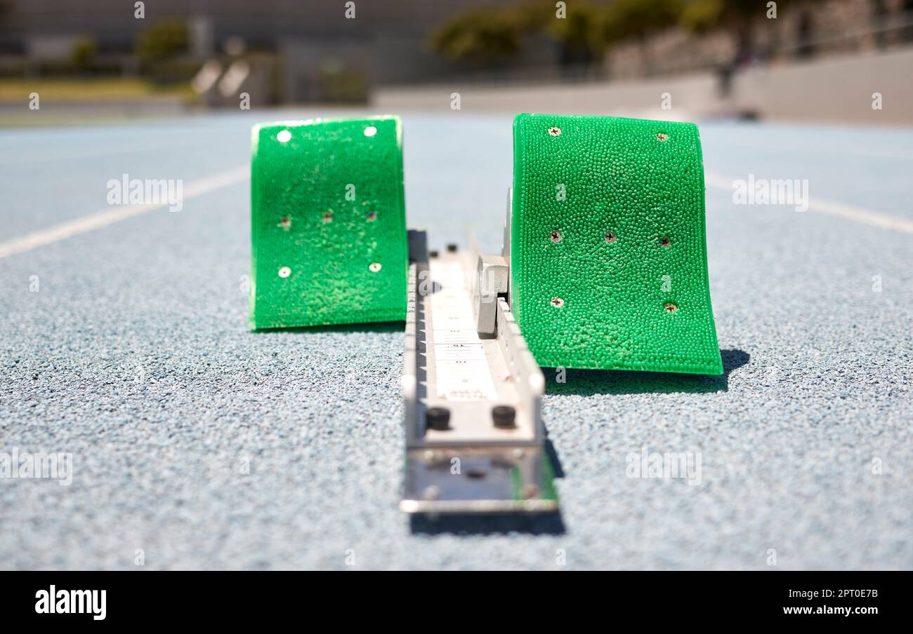Sports, athletics and start block on track in outdoor stadium for ...