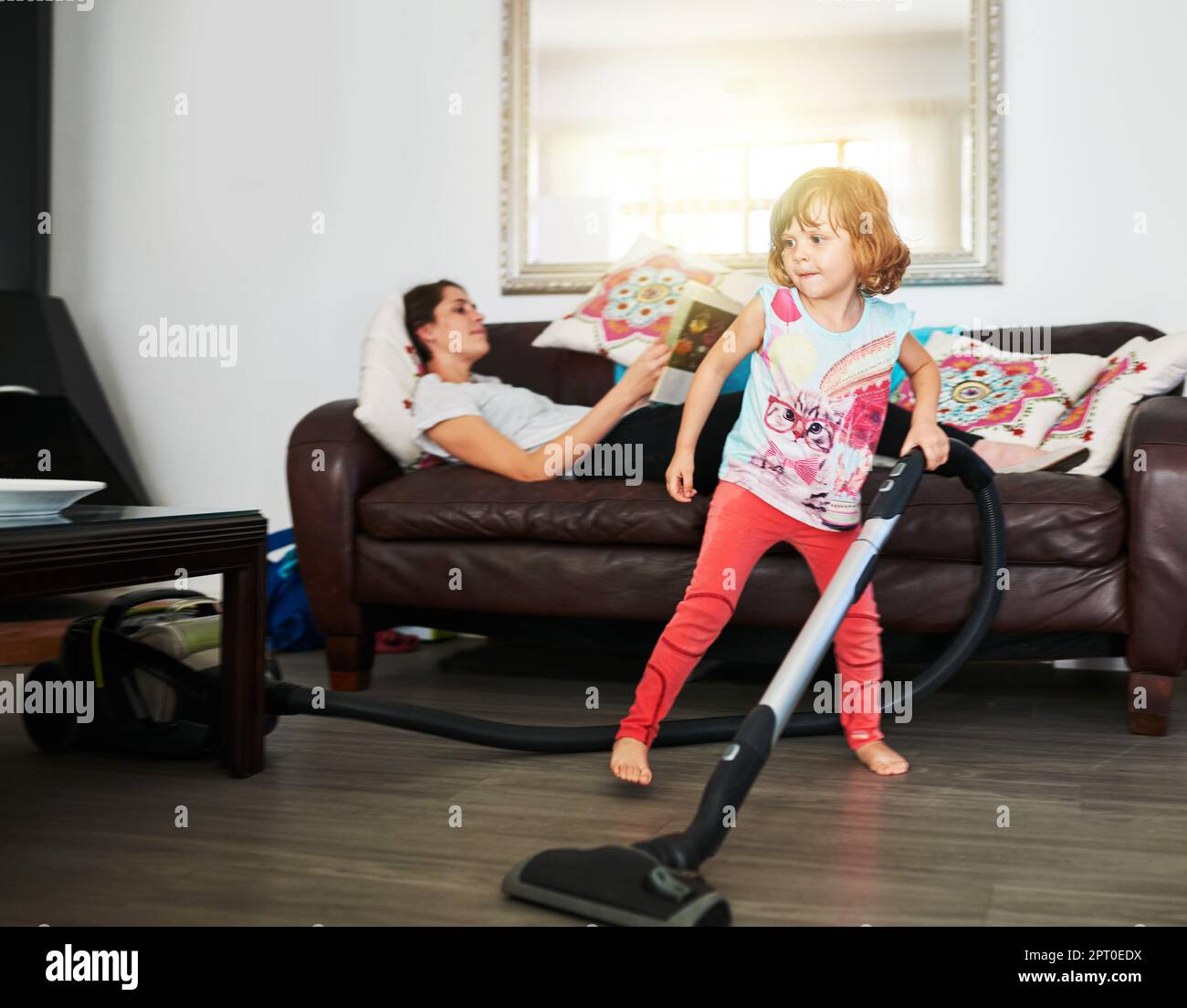 Shes giving mom a break. a mother lying down on a couch while her ...
