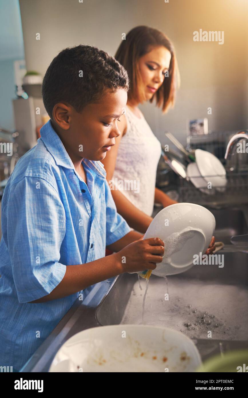 Boy helping mother with chores hi-res stock photography and images - Alamy
