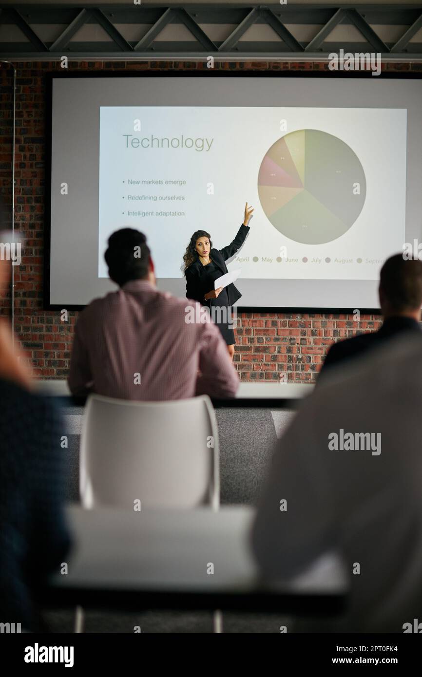 Delivering important quarterly updates. a businesswoman giving a ...