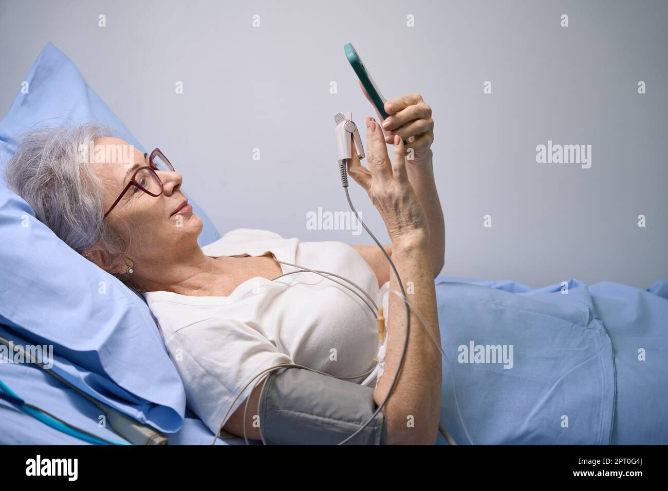 Recovering patient is chatting on mobile phone from hospital room Stock ...
