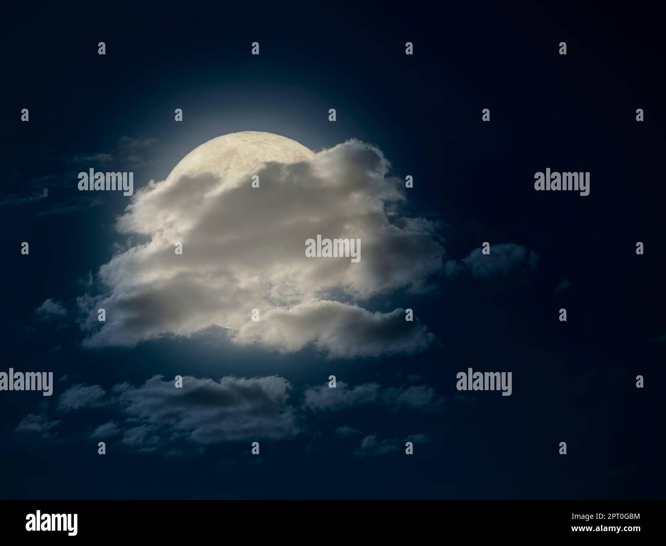 Full moon covered by a strong cloud in a dark night Stock Photo - Alamy