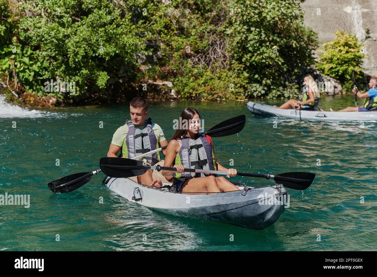 A group of friends enjoying having fun and kayaking while exploring the ...