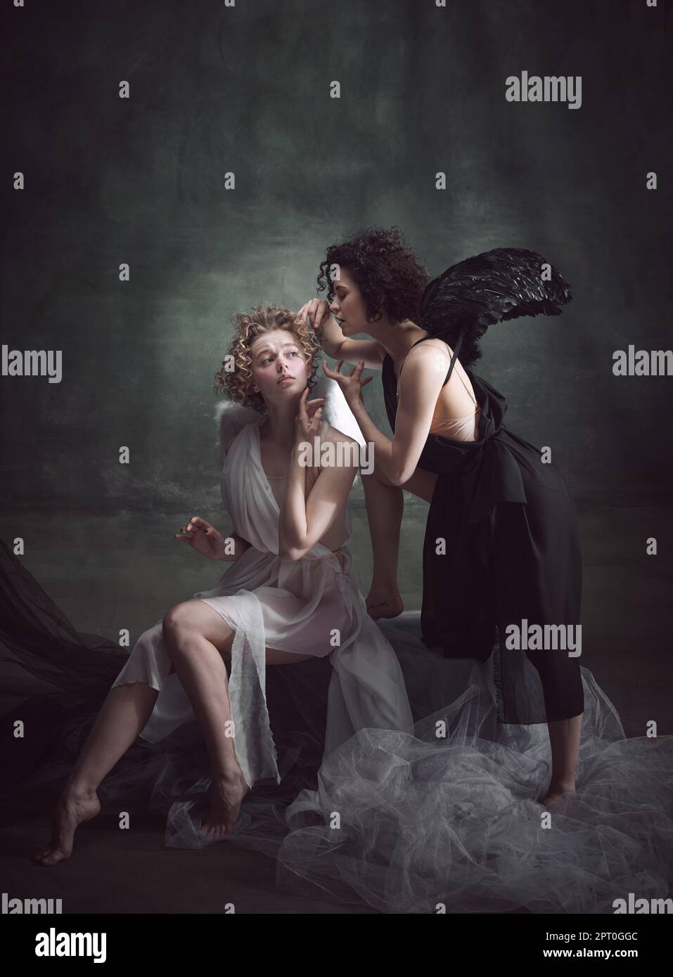 Devilish woman whispering to naive angel. Portrait of two women, angel ...