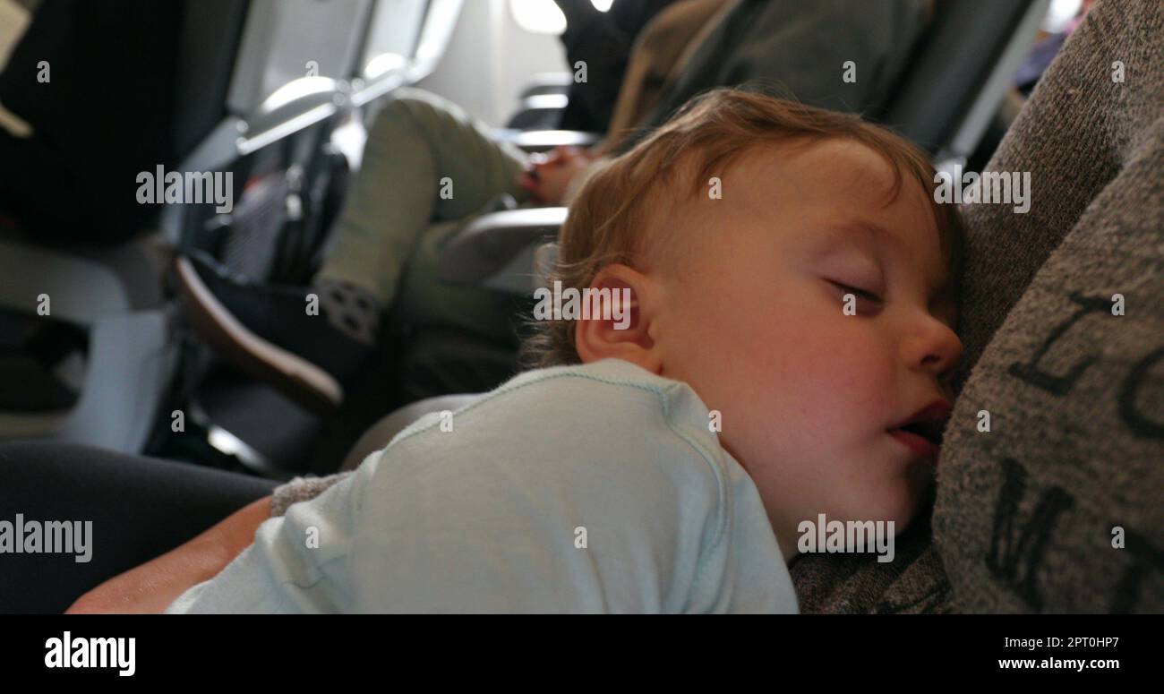 Kid sleeping plane hi-res stock photography and images - Alamy