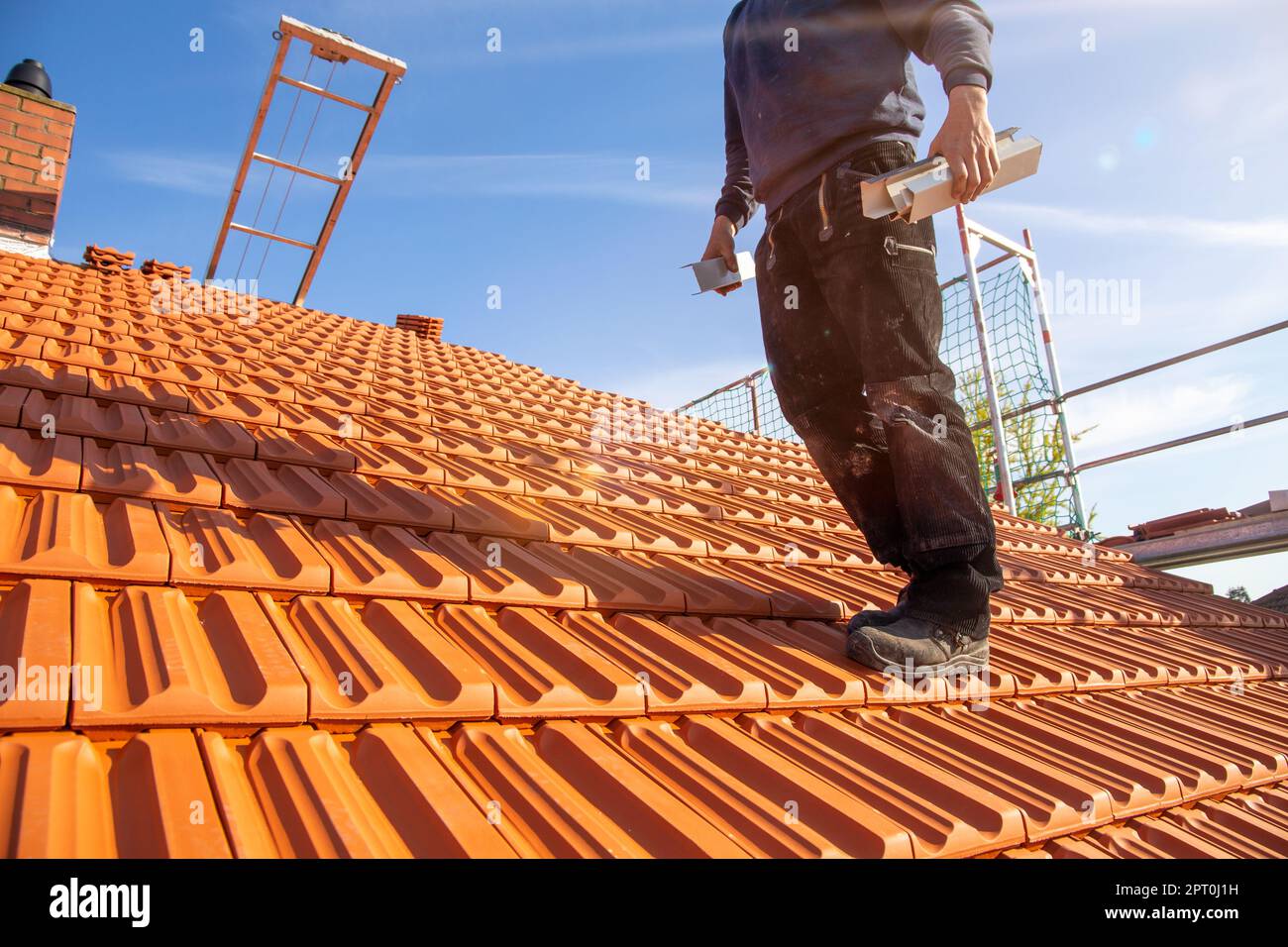 Roofing work, new covering of a tiled roof Stock Photo - Alamy