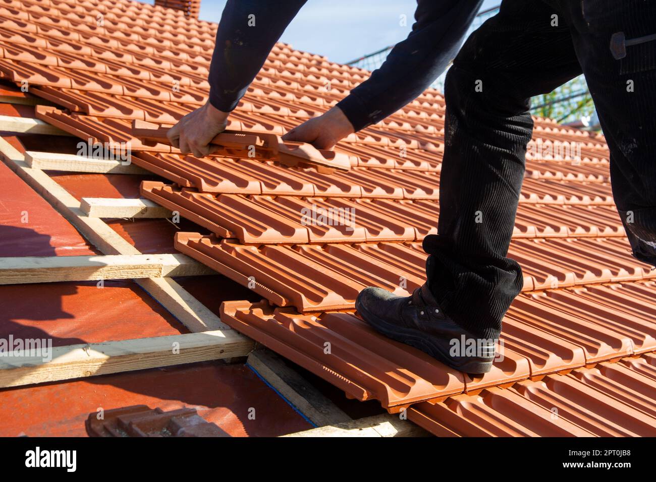Roofing work, new covering of a tiled roof Stock Photo - Alamy