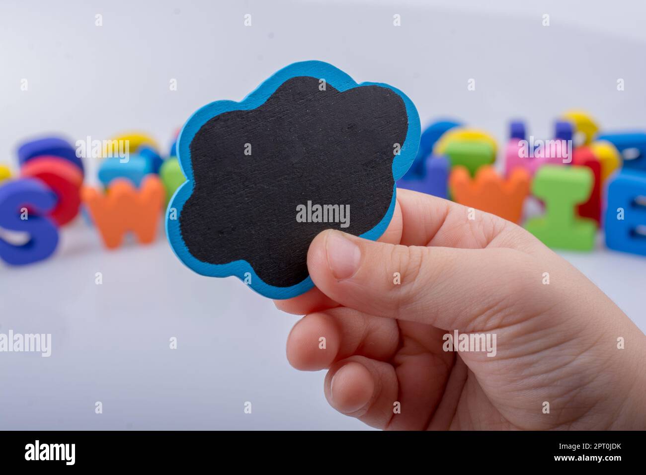 Speech bubble in hand with colorful letters behind Stock Photo - Alamy