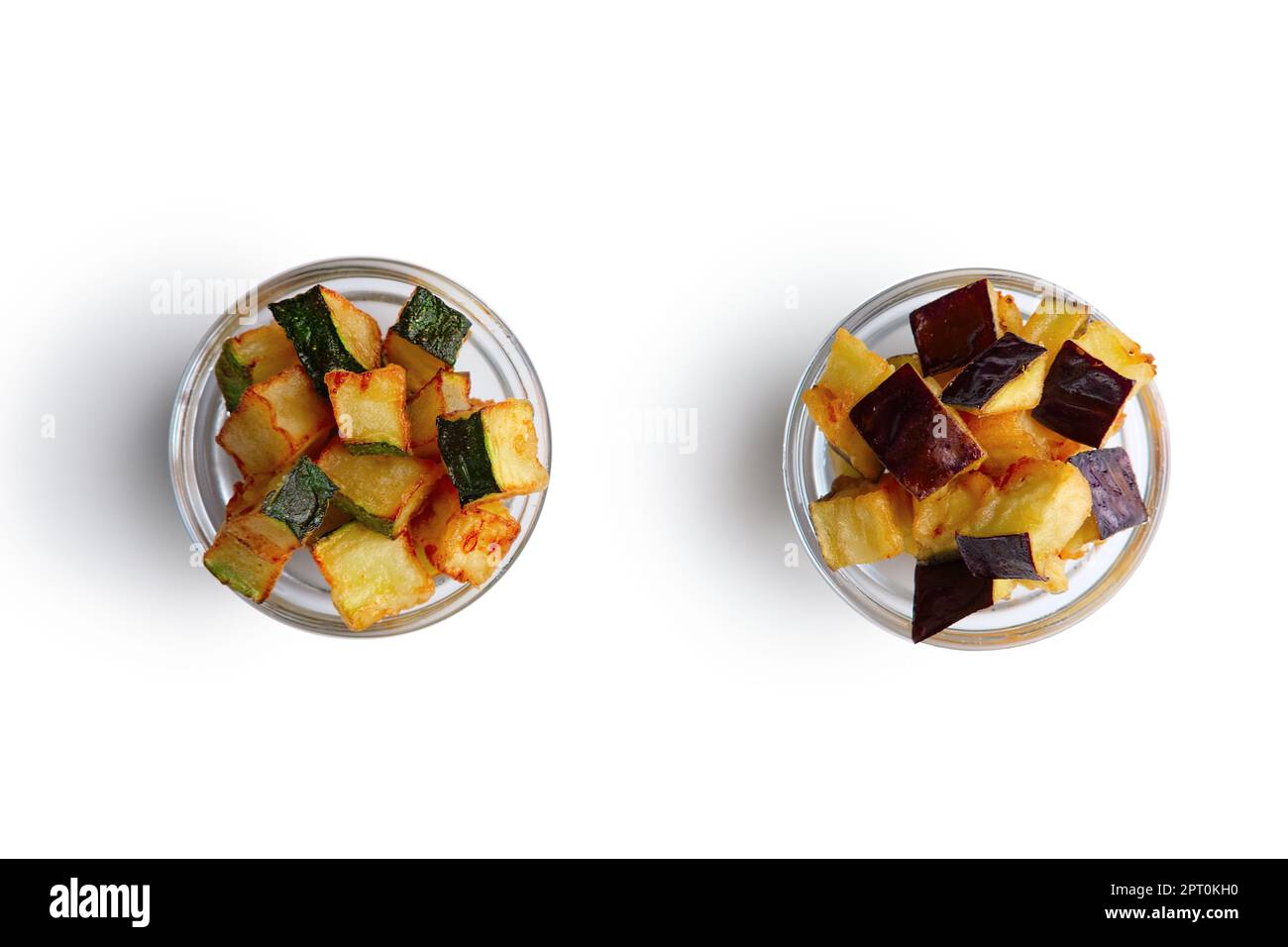 Fried square chips made of aubergine and zucchini in round glass plates ...