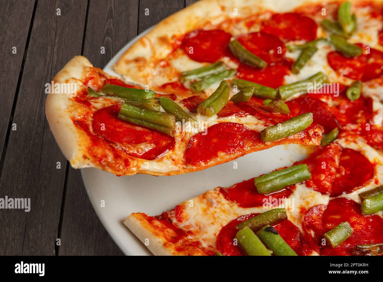 Slice of levitatating pizza pepperoni on scapula Stock Photo - Alamy