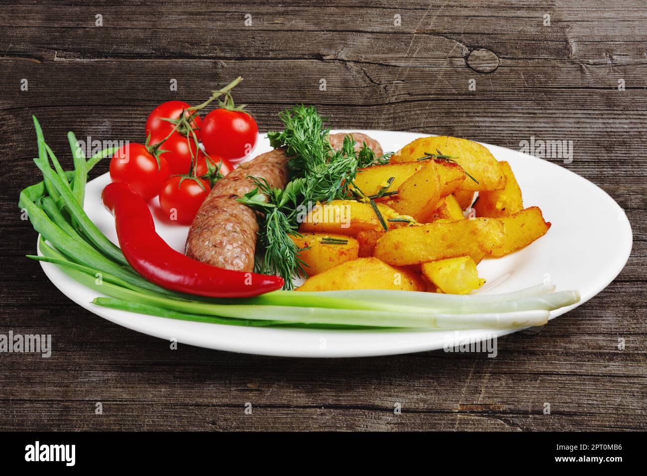 homemade sausage with fried potato, tomato cherry, pepper and green ...