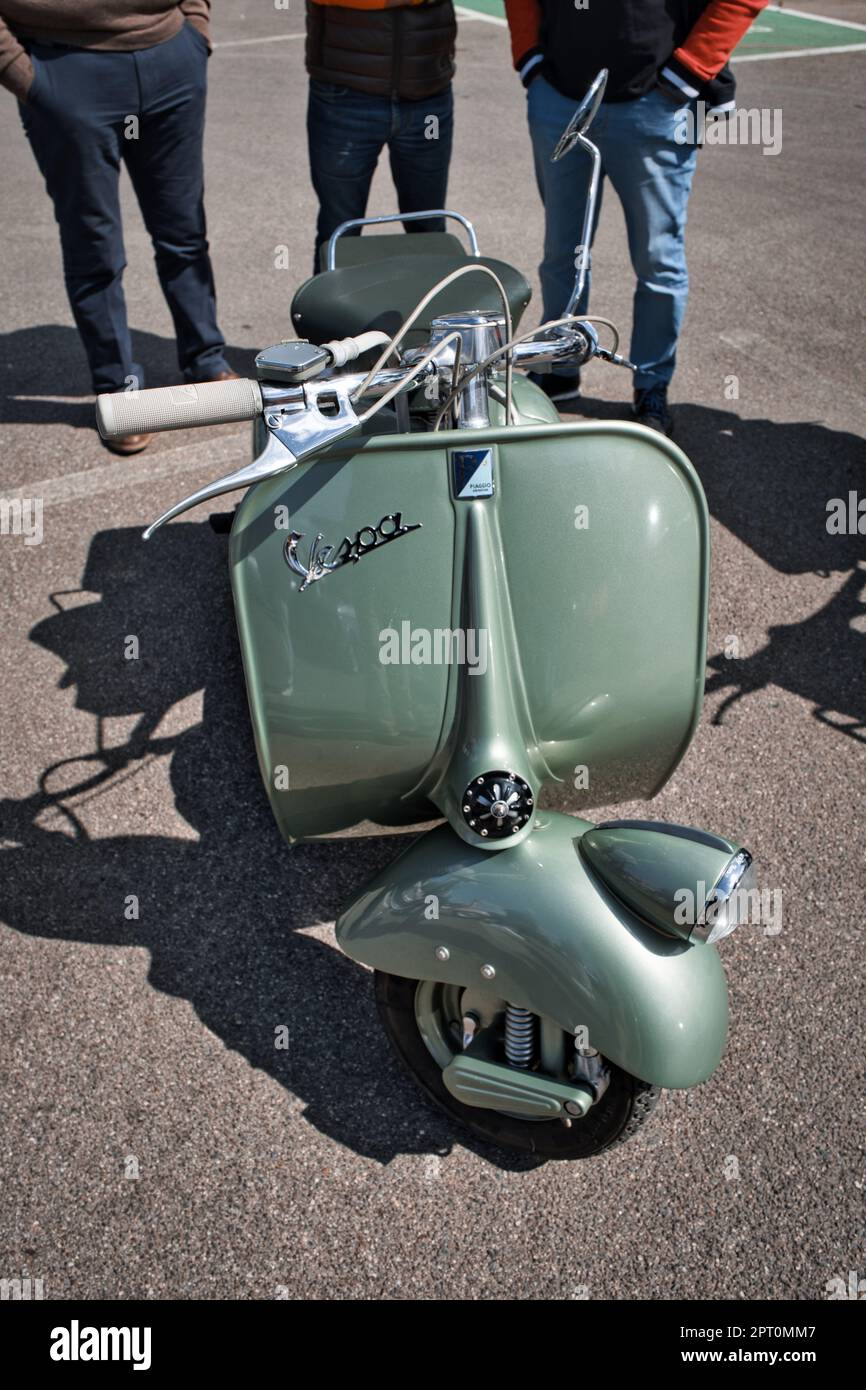People looking a perfectly restored ancient Vespa at a collector ...