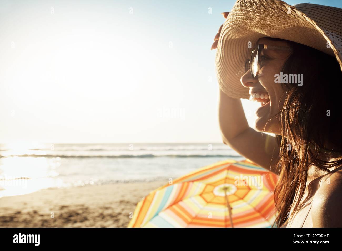 Loving every moment at the beach. a beautiful young woman at the beach ...