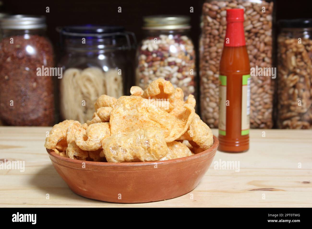 Fried Pork Rinds With Hot Sauce in Rustic Kitchen Stock Photo - Alamy