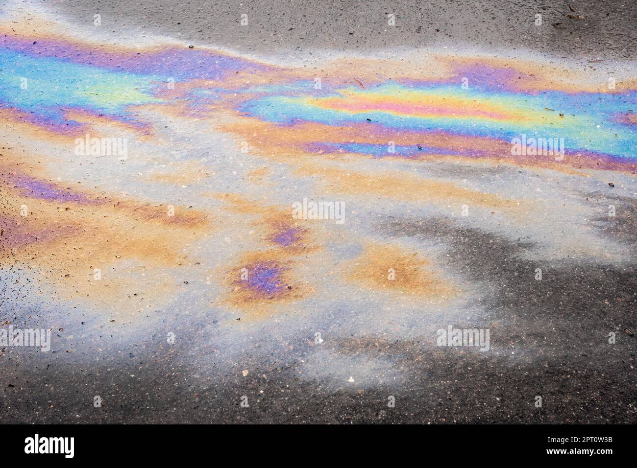 Colored texture of oil products on the asphalt in the rain. Bold ...