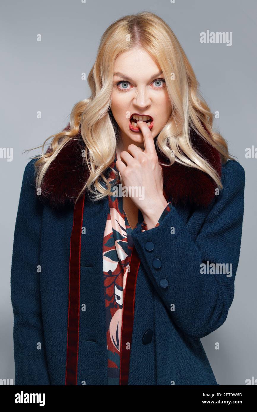 Pretty discouraged girl biting finger, uncertain mood. Portrait of lady ...