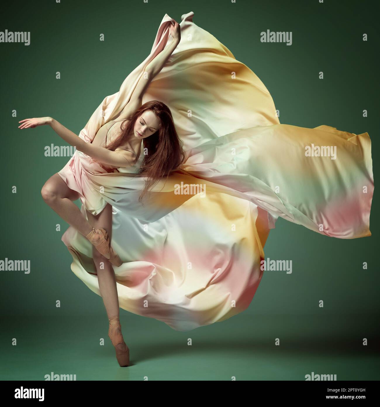 Portrait of inspired young ballerina, beautiful girl wearing silk dress and dancing with emotion ...