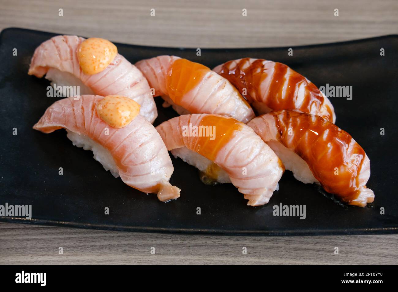 Set of Salmon aburi sushi with sauce on plate Stock Photo - Alamy
