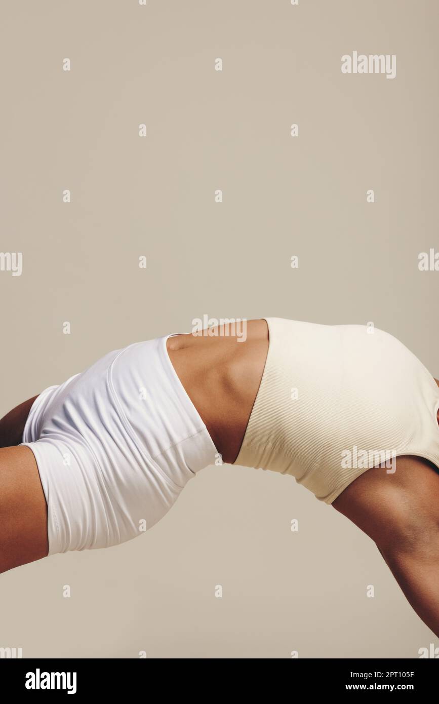 Fit young woman showcasing her impressive handstand skills, balancing ...