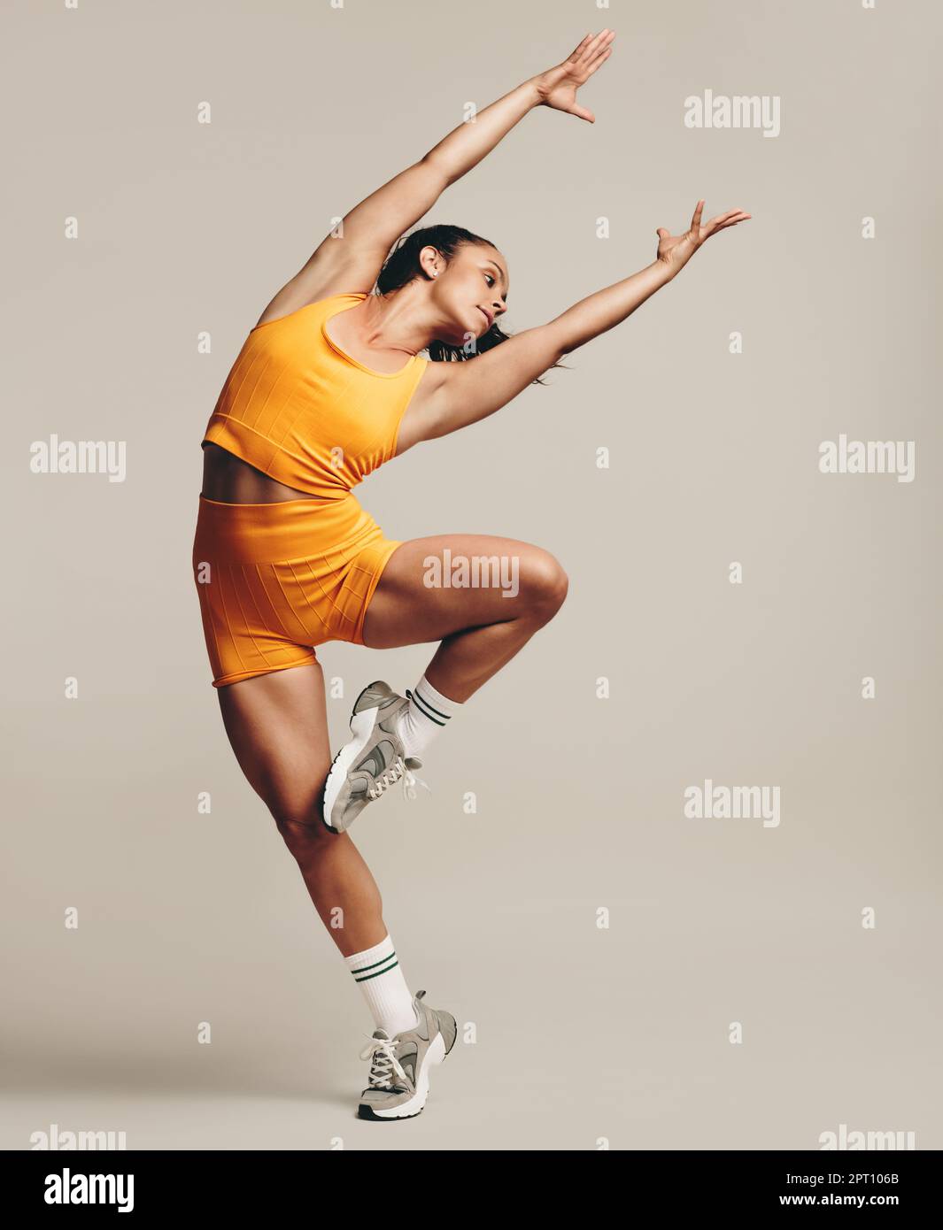 Flexible female athlete performing a gymnastics workout, balancing on ...