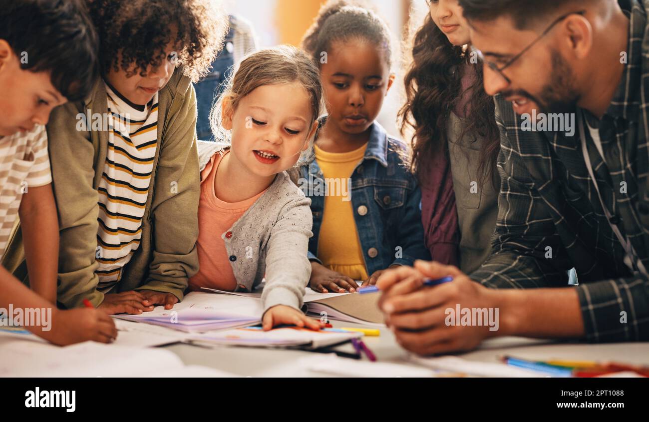 Students doing a creativity project with their teacher in a classroom ...
