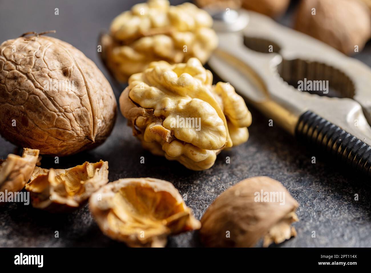 Peeled walnut on the dark table Stock Photo - Alamy