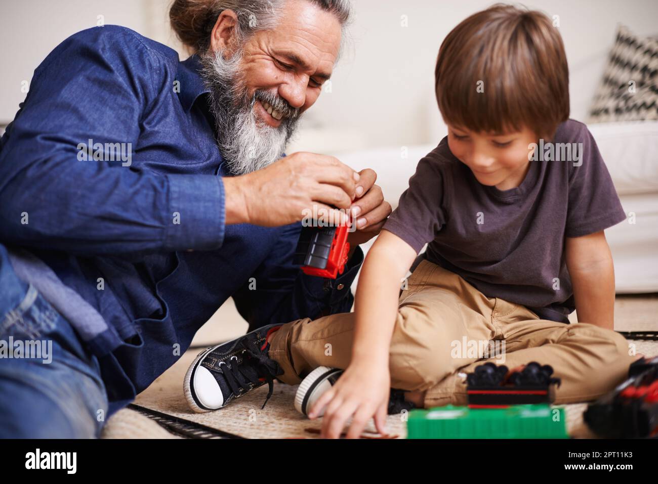 Building a train set with his best buddy. a grandfather and his ...