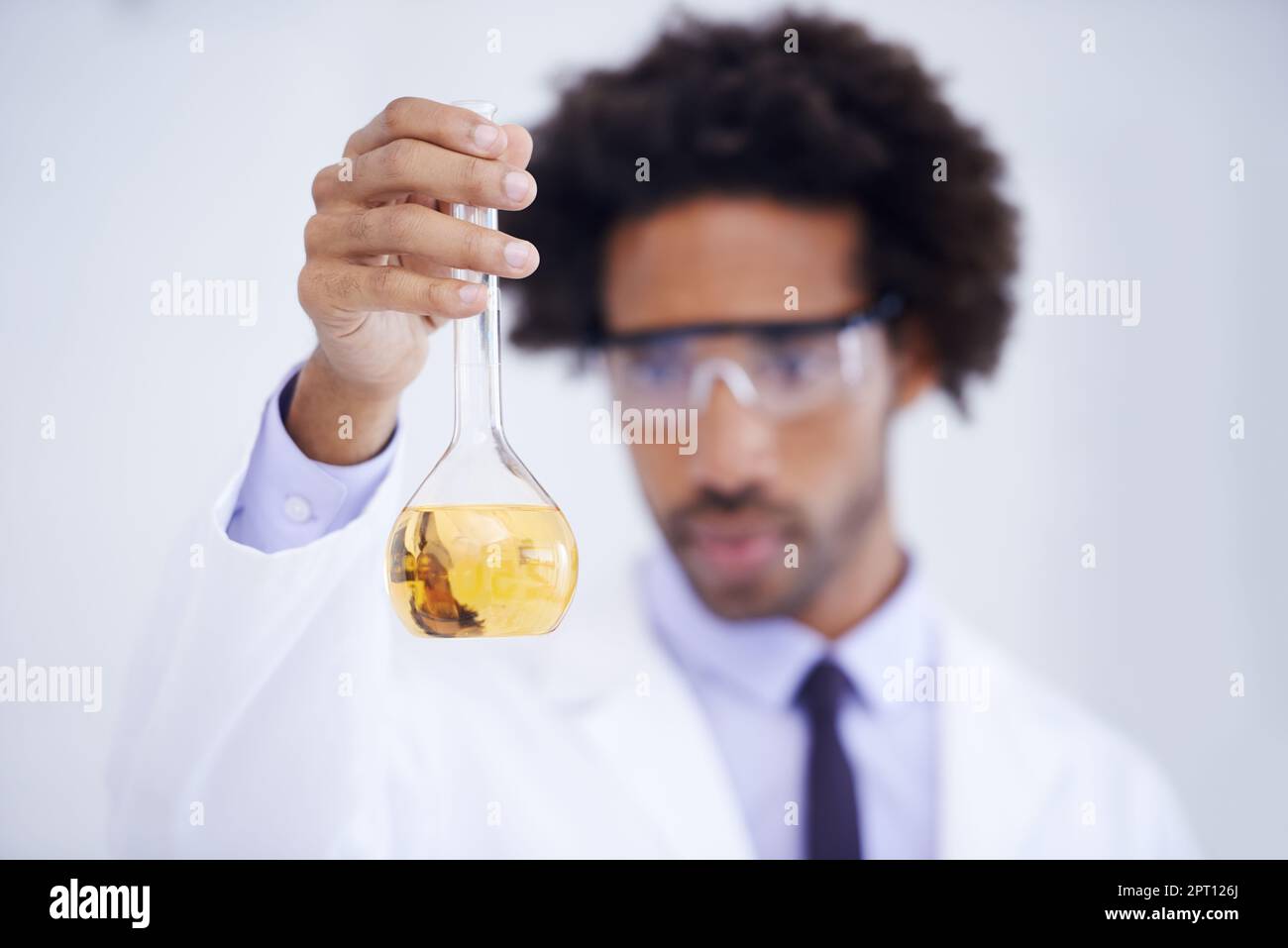 This looks promising. a male scientist conducting an experiment in his lab Stock Photo - Alamy
