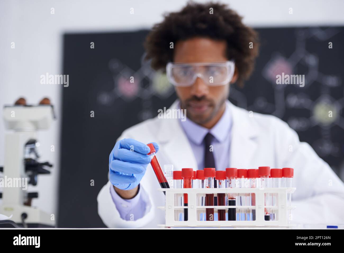 One test tube after another. a male medical scientist conducting blood ...
