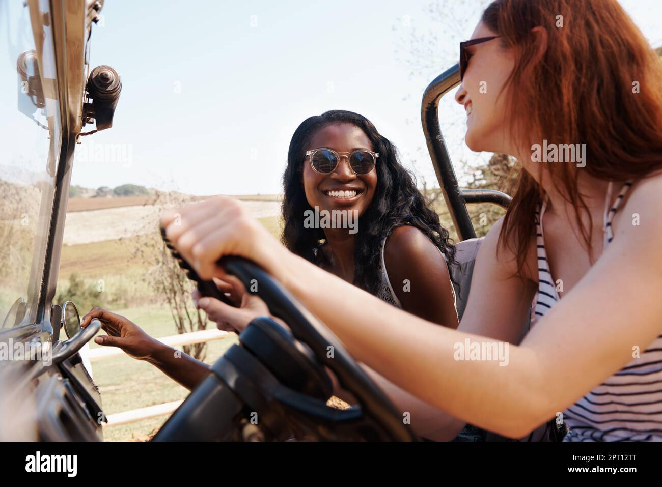 My best friend makes long car rides bearable. two smiling young woman ...