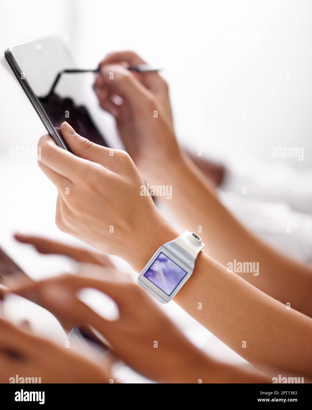 Multi-tasking made easy. A row of hands using digital devices - All ...