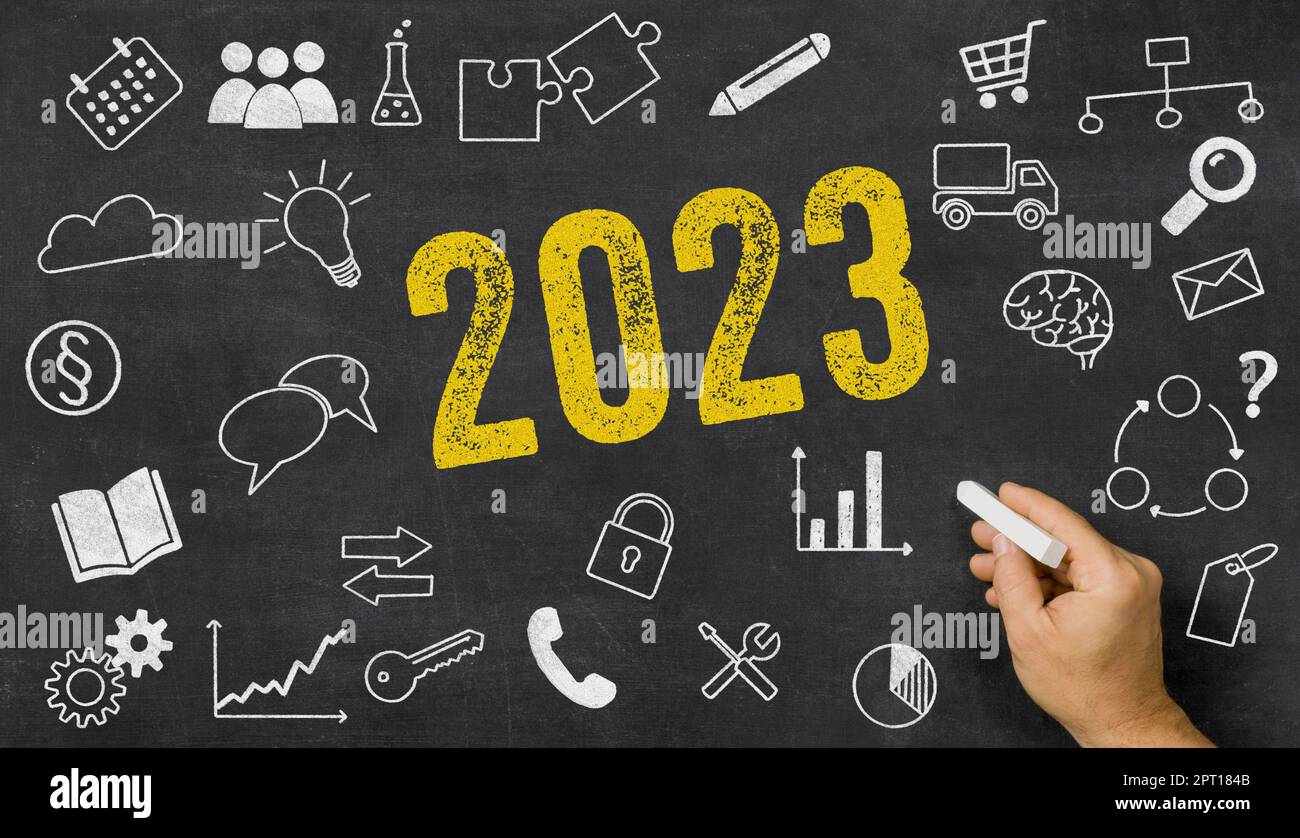 2023 written on a blackboard with icons Stock Photo - Alamy