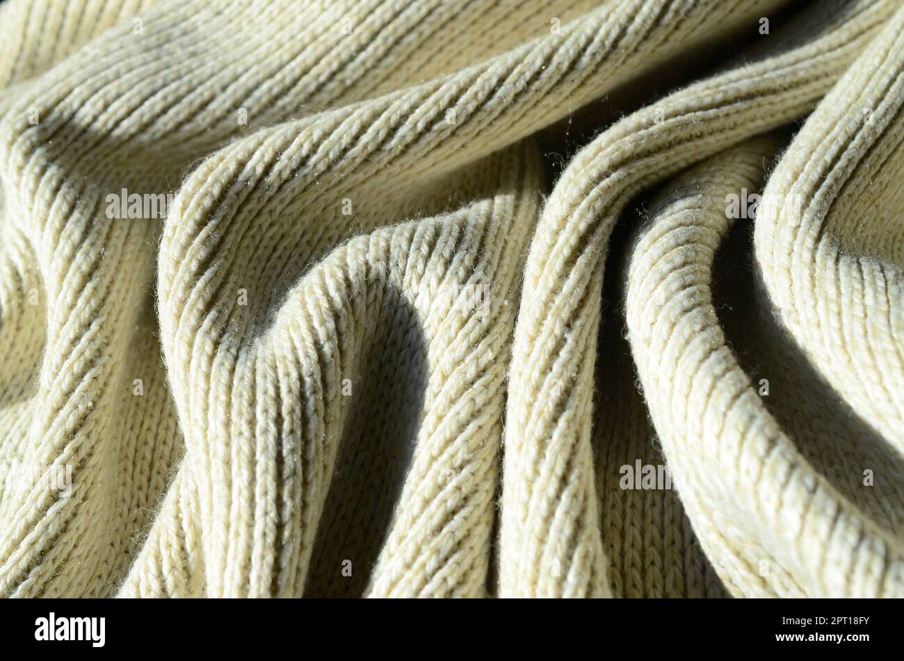 Fabric texture of a soft yellow knitted sweater. Macro image of the ...