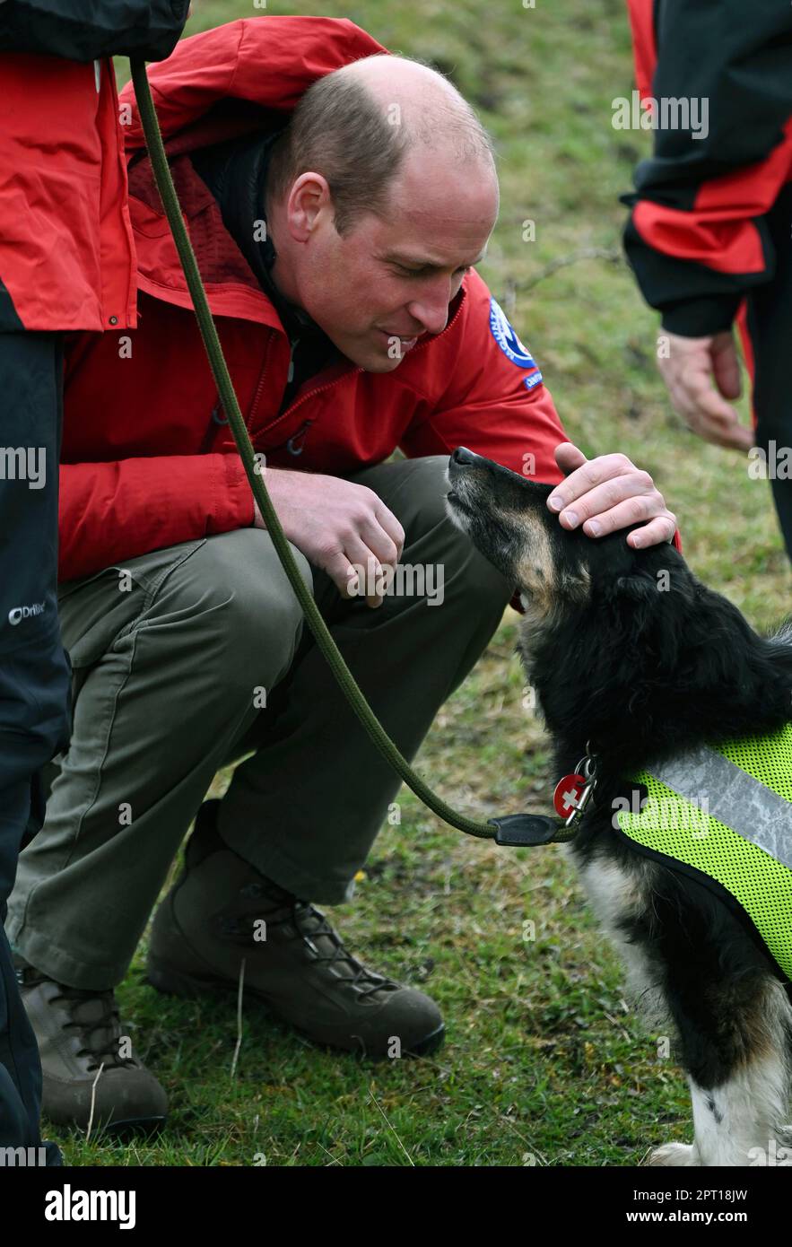 Britain's Prince William, Prince of Wales strokes a dog during a dog ...
