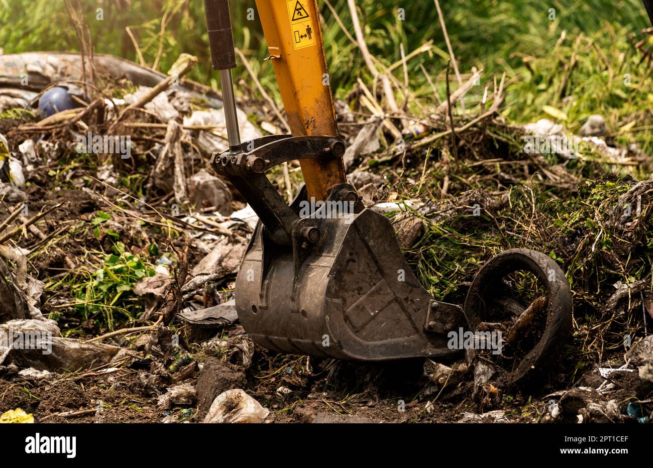 Backhoe digging soil at construction site. Bucket of backhoe digging ...