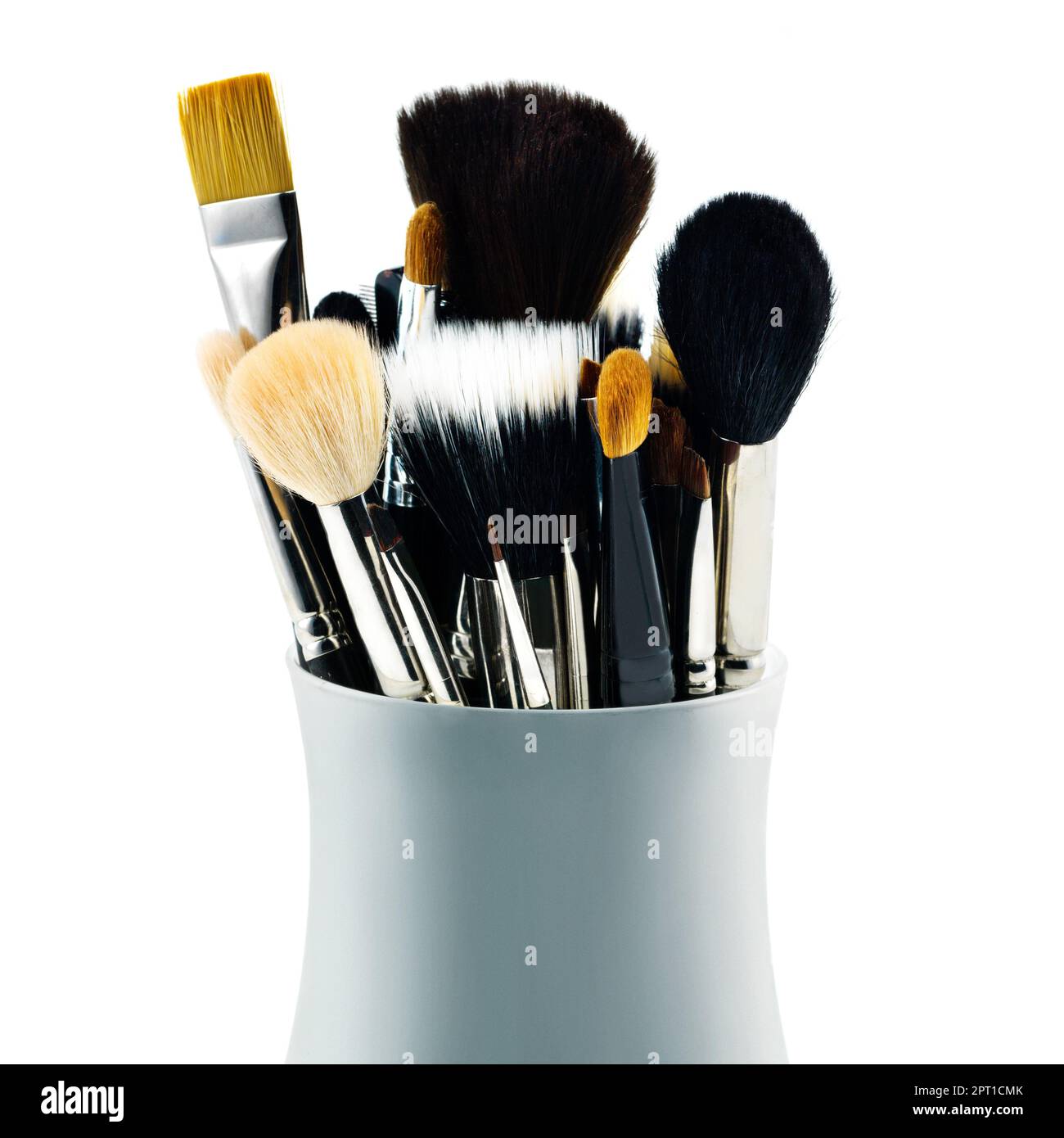 Tools of the beauty trade. A set of makeup brushes in their container ...