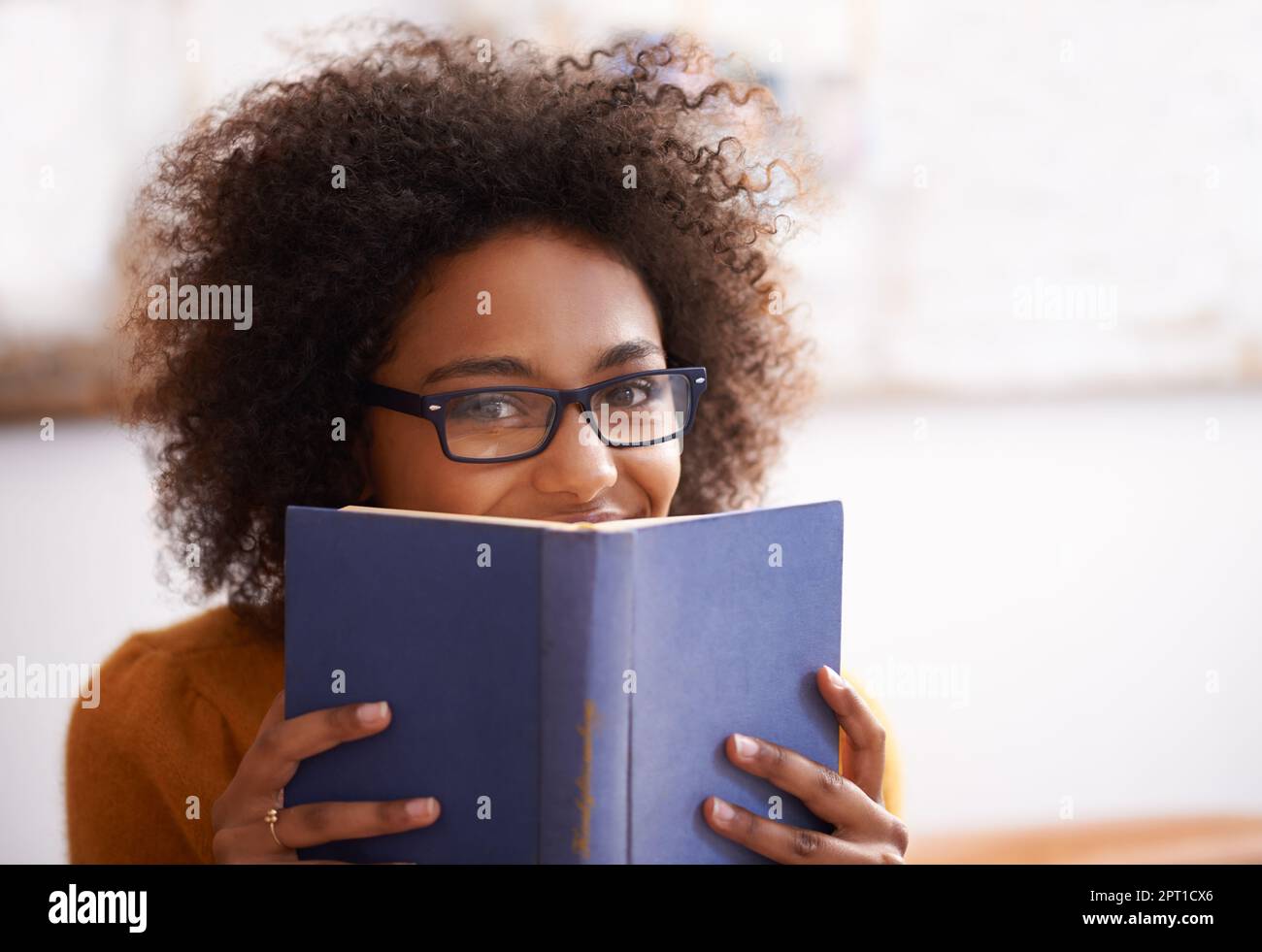 Woman peering over glasses hi-res stock photography and images - Alamy