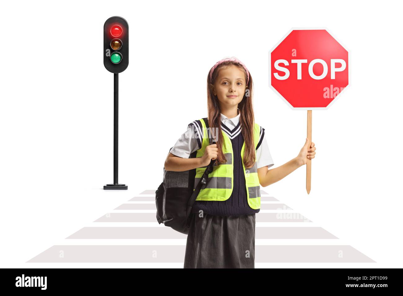 Girl in a safety vest holding a stop traffic sign on the street ...