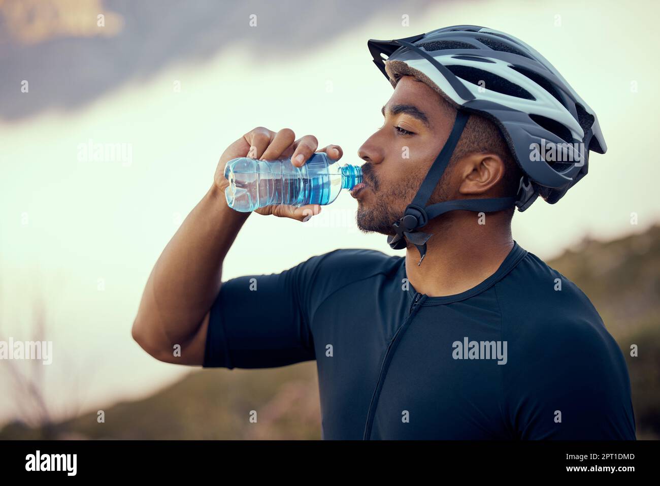 Fitness man, cycling and drinking water bottle and wearing safety ...