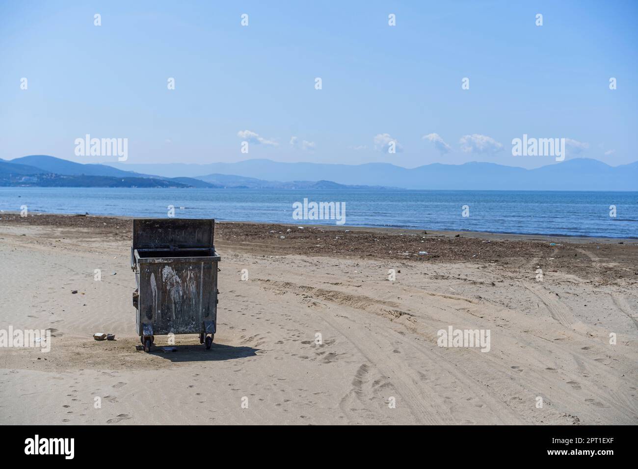 A big metal trash bin on an empty beach Stock Photo - Alamy