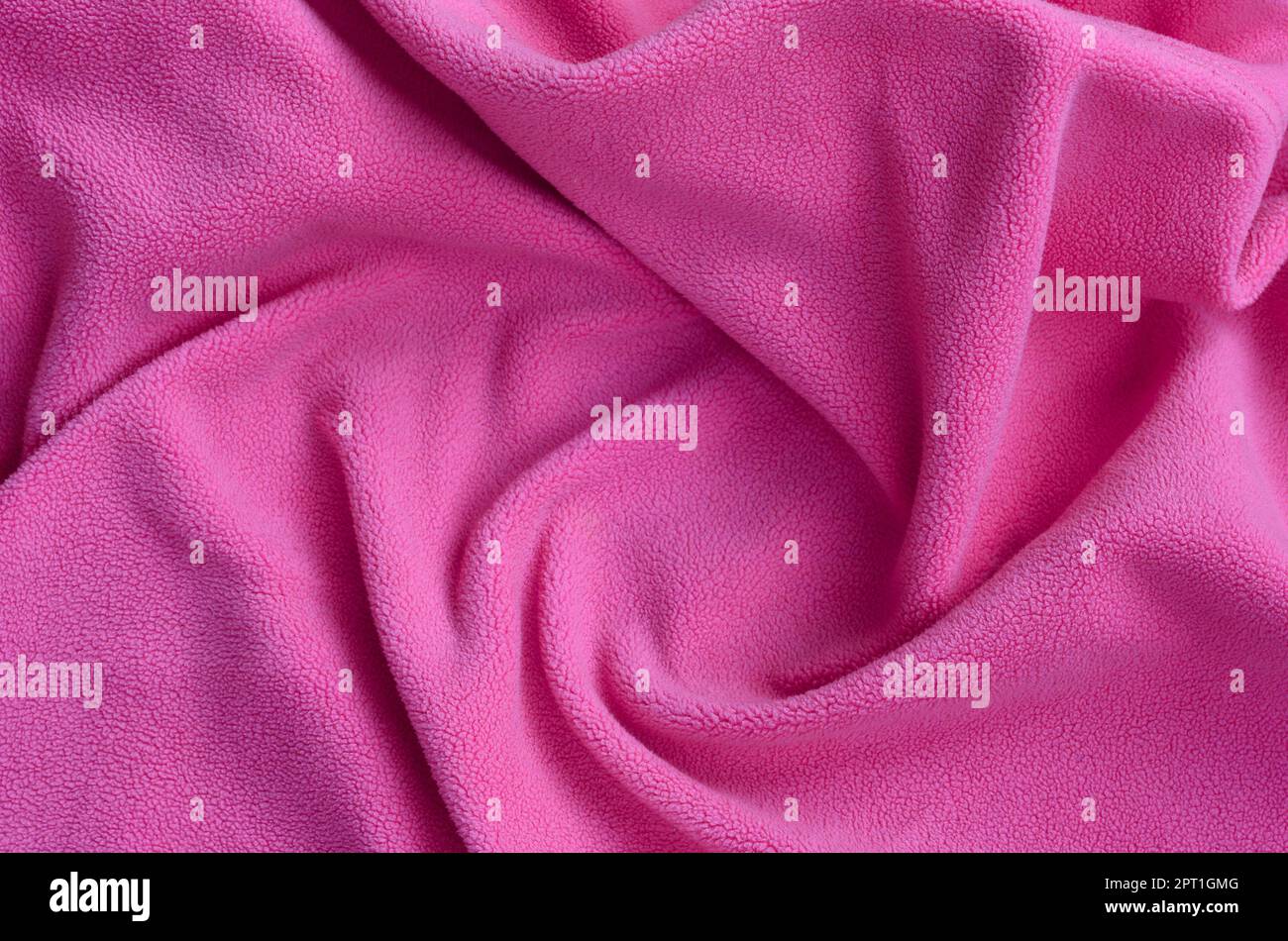 The blanket of furry pink fleece fabric. A background of light pink ...