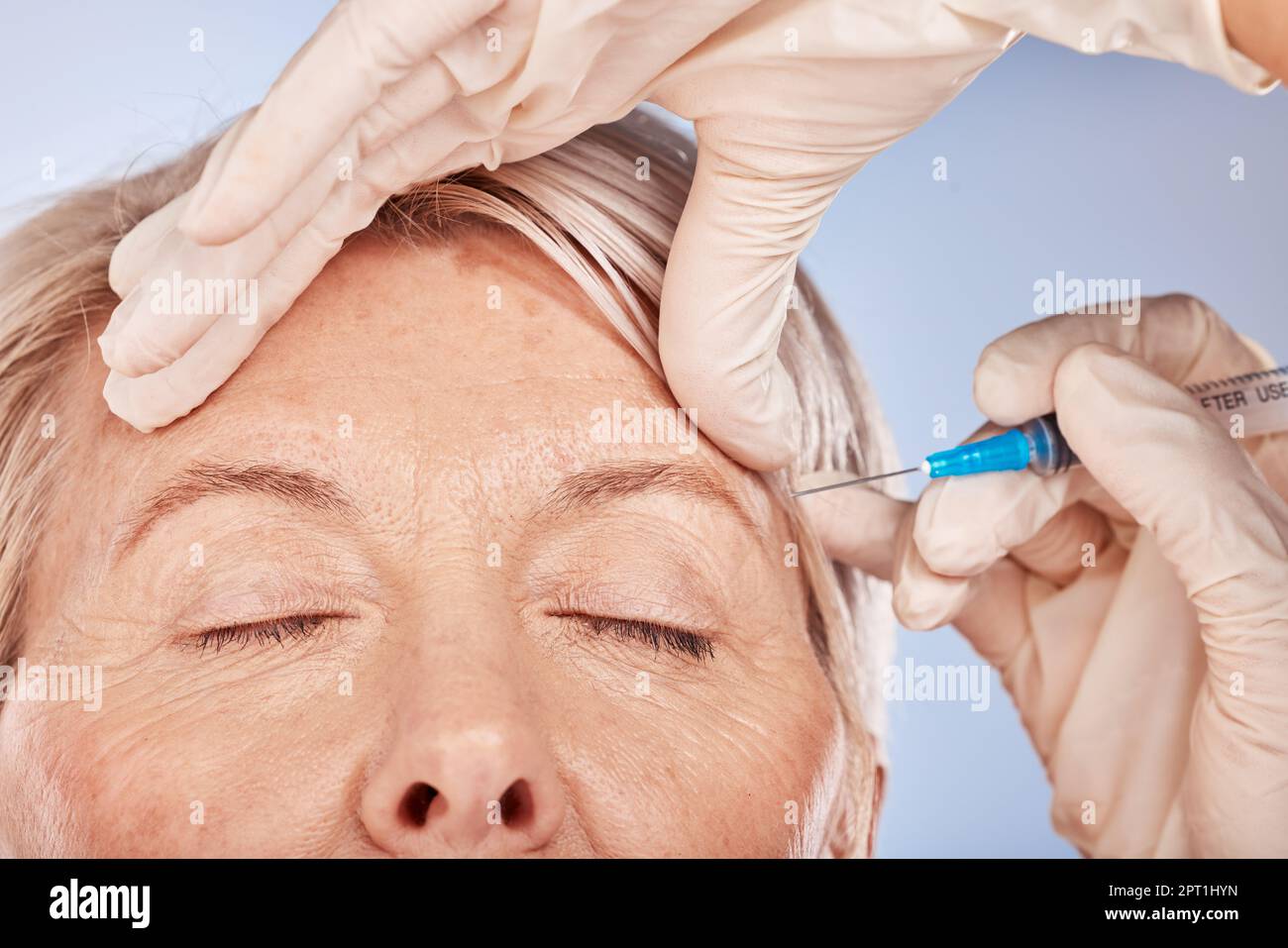 Face, hand and syringe for botox, cosmetic surgery and beauty against a ...