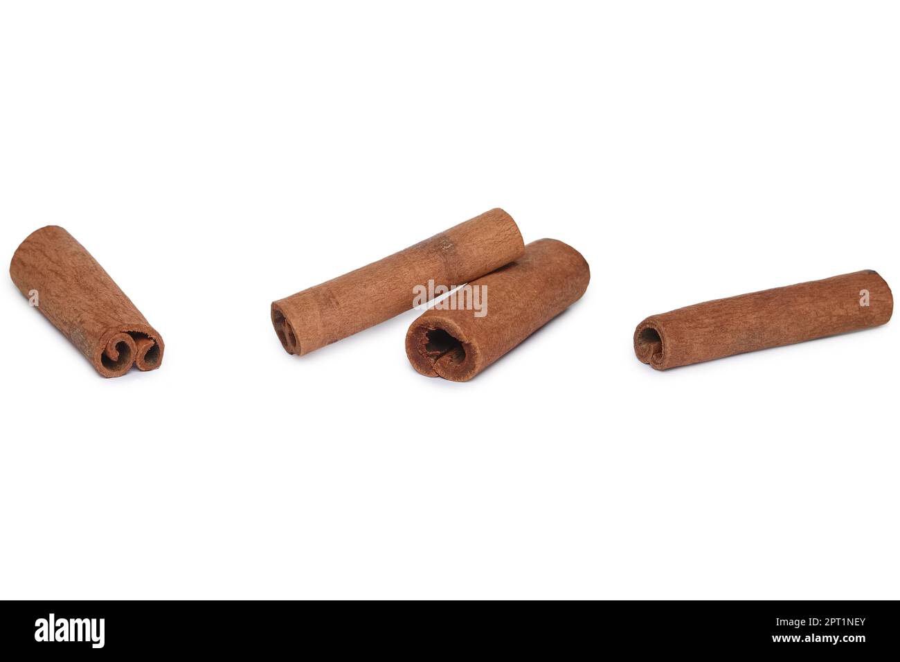 Four cinnamon sticks on white background with shadow Stock Photo - Alamy