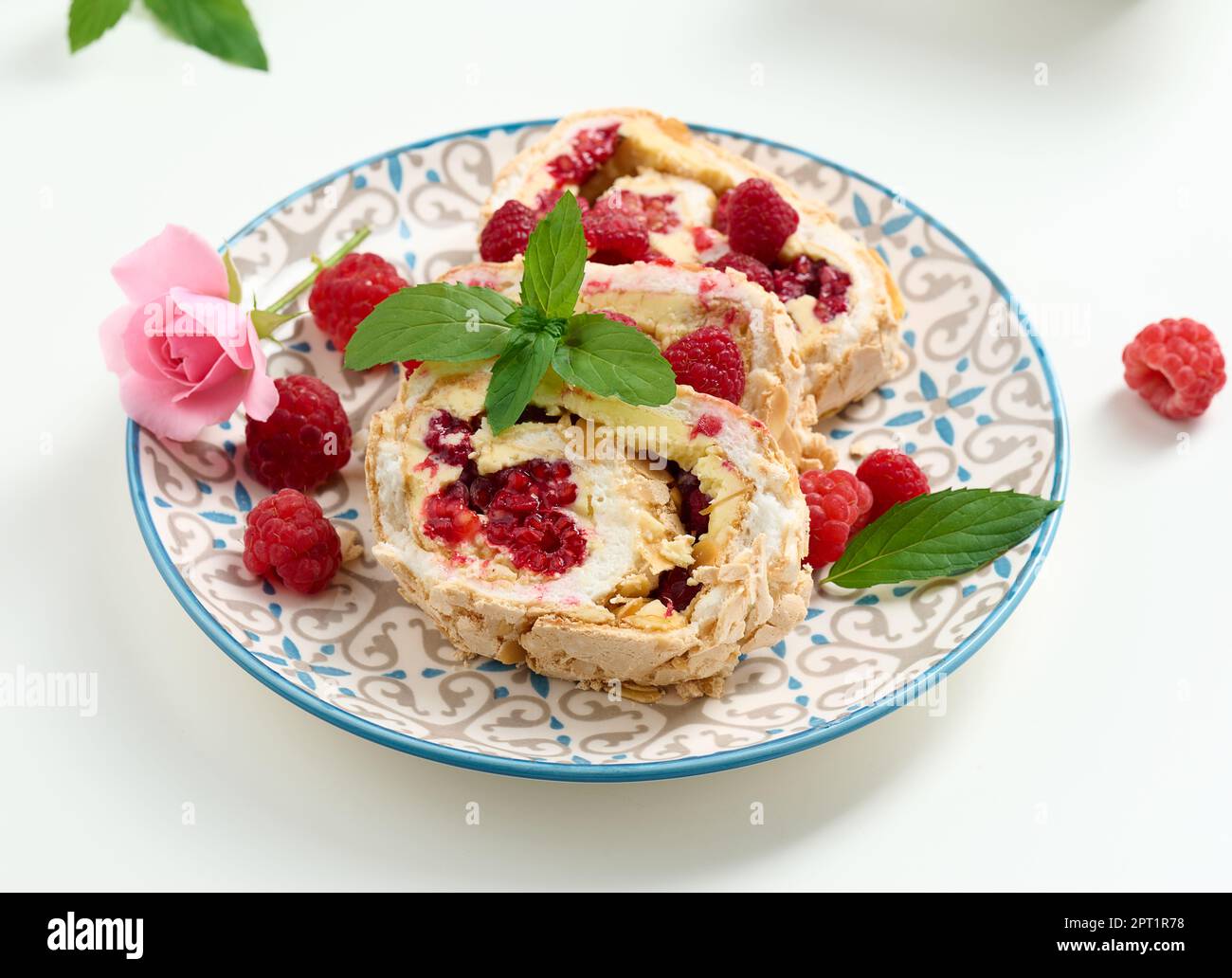 Baked meringue roll with cream and fresh red raspberry, white ...
