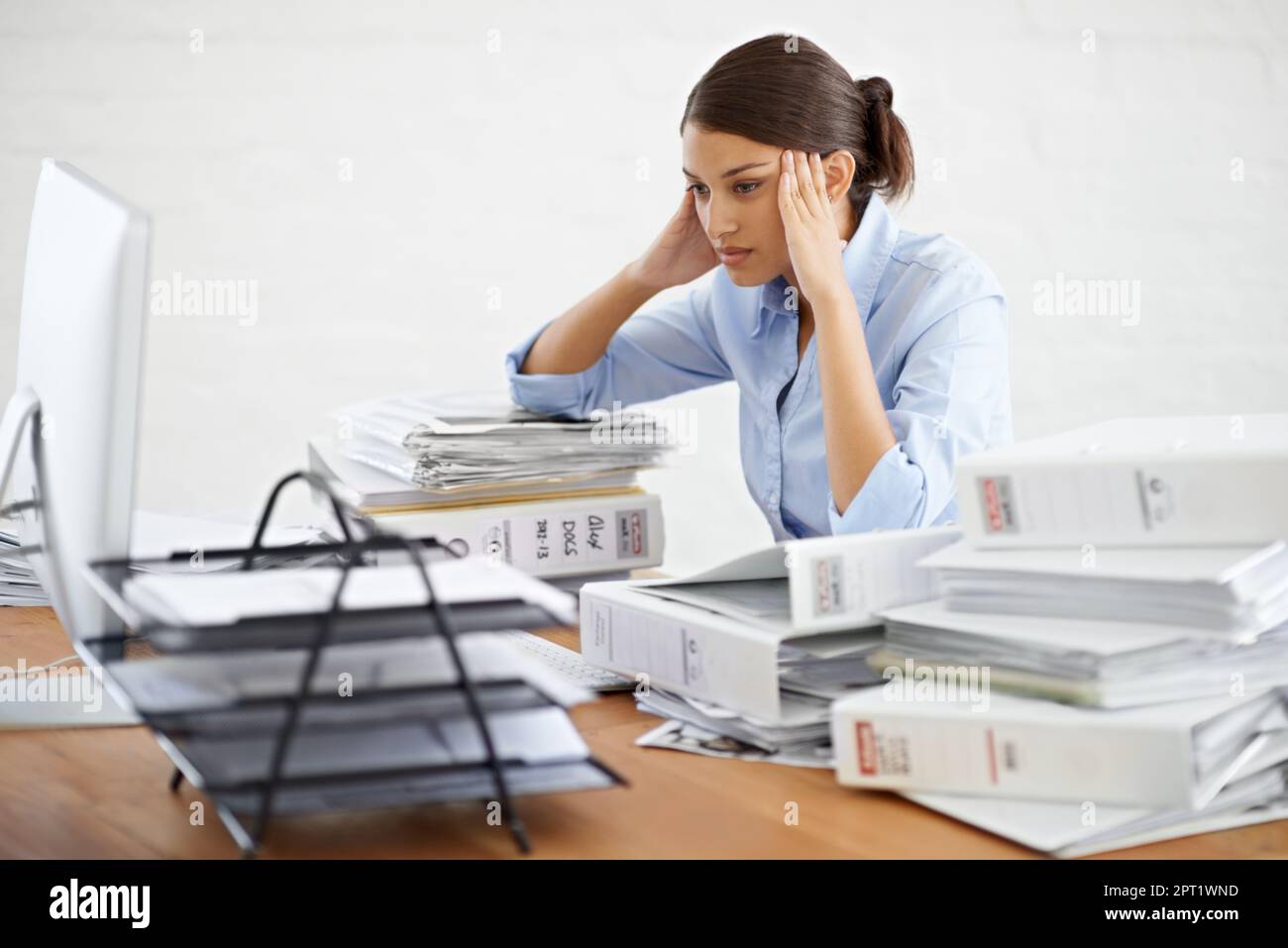 This is mind-numbing work. A young businesswoman looking overwhelmed ...