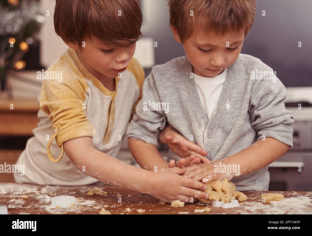 No, youre doing it wrong. two young brothers baking in the kitchen ...
