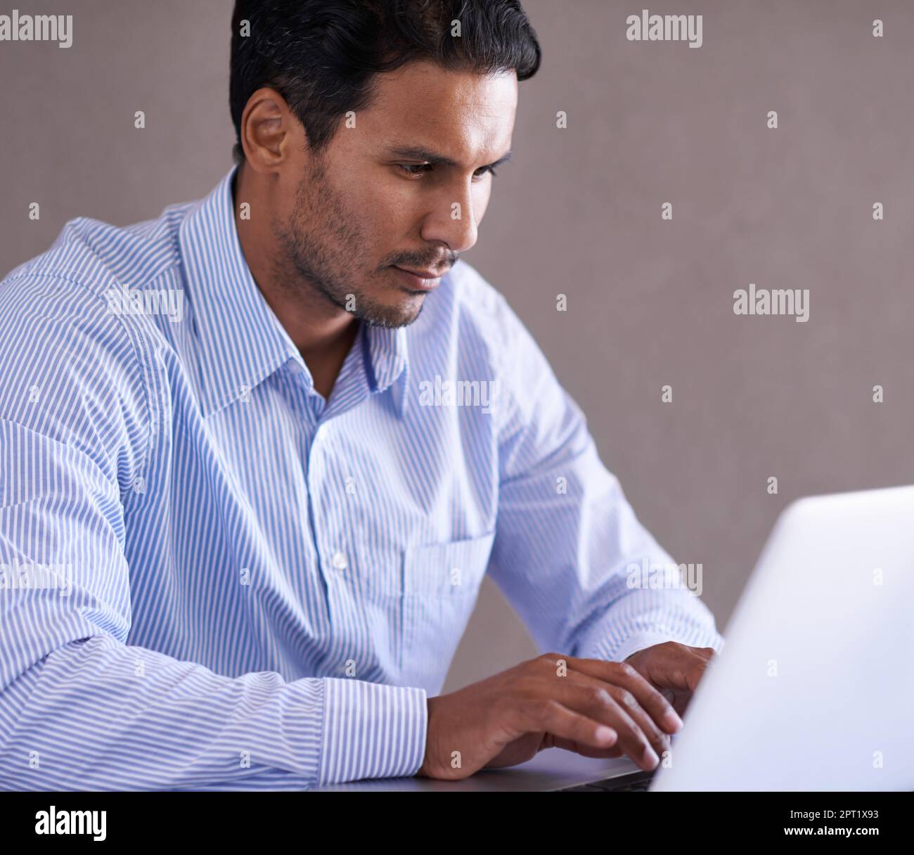 Hes working hard to complete his tasks. a handsome young businessman ...