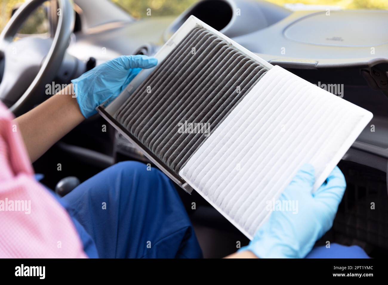 Replacing the cabin pollen air filter for a car Stock Photo - Alamy